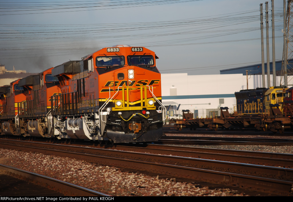 BNSF 6833 with the Sun's Rays Gleeming Off Her GE/BNSF Swoosh Logo Paint heads east with the S ...